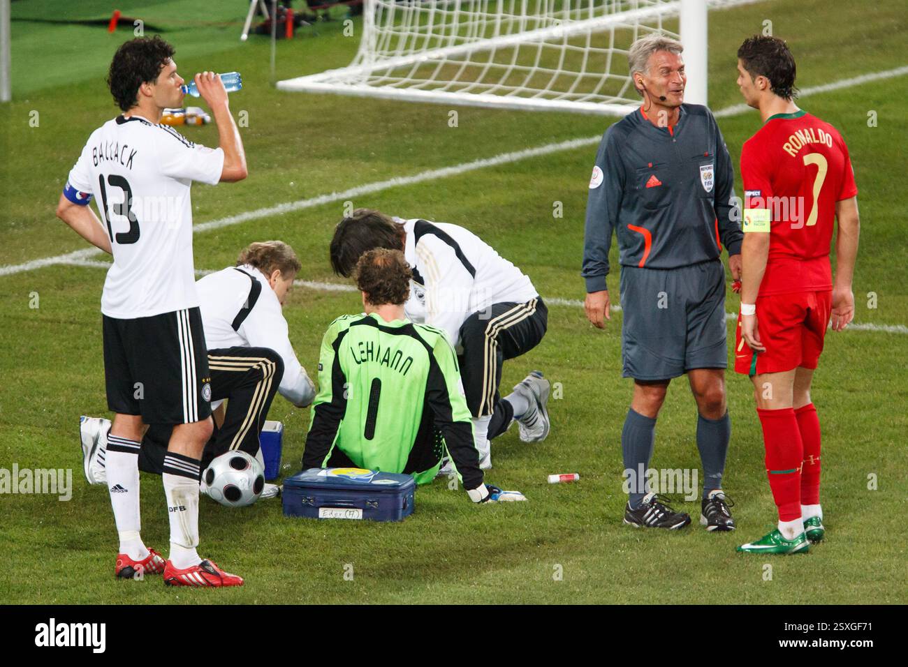 Goalkeeper Jens Lehmann of Germany (1) is treated by medical staff as ...