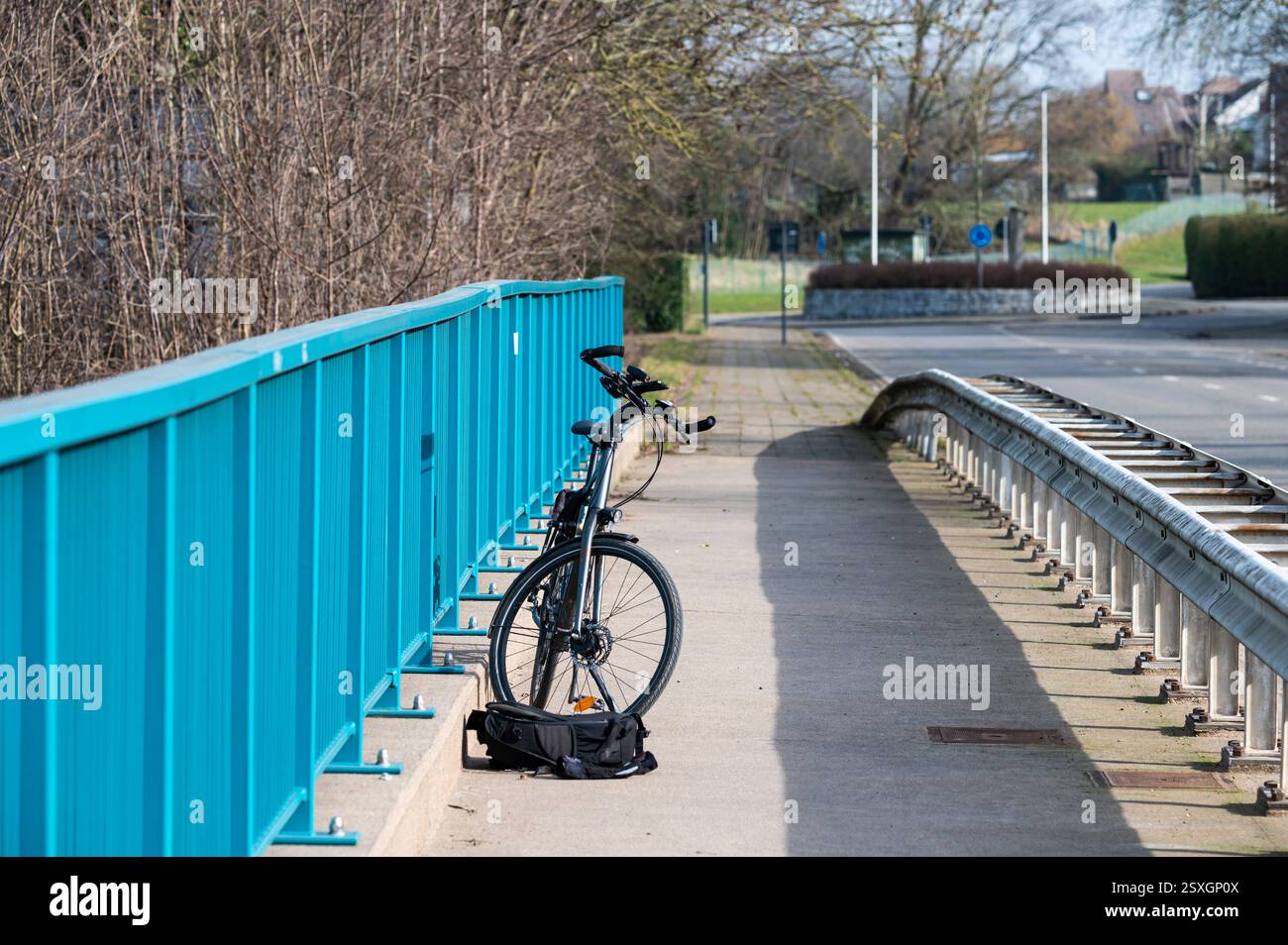 City bike standing on a bridge with a rail ramp protection over the Brussels ringroad in Dilbeek ...