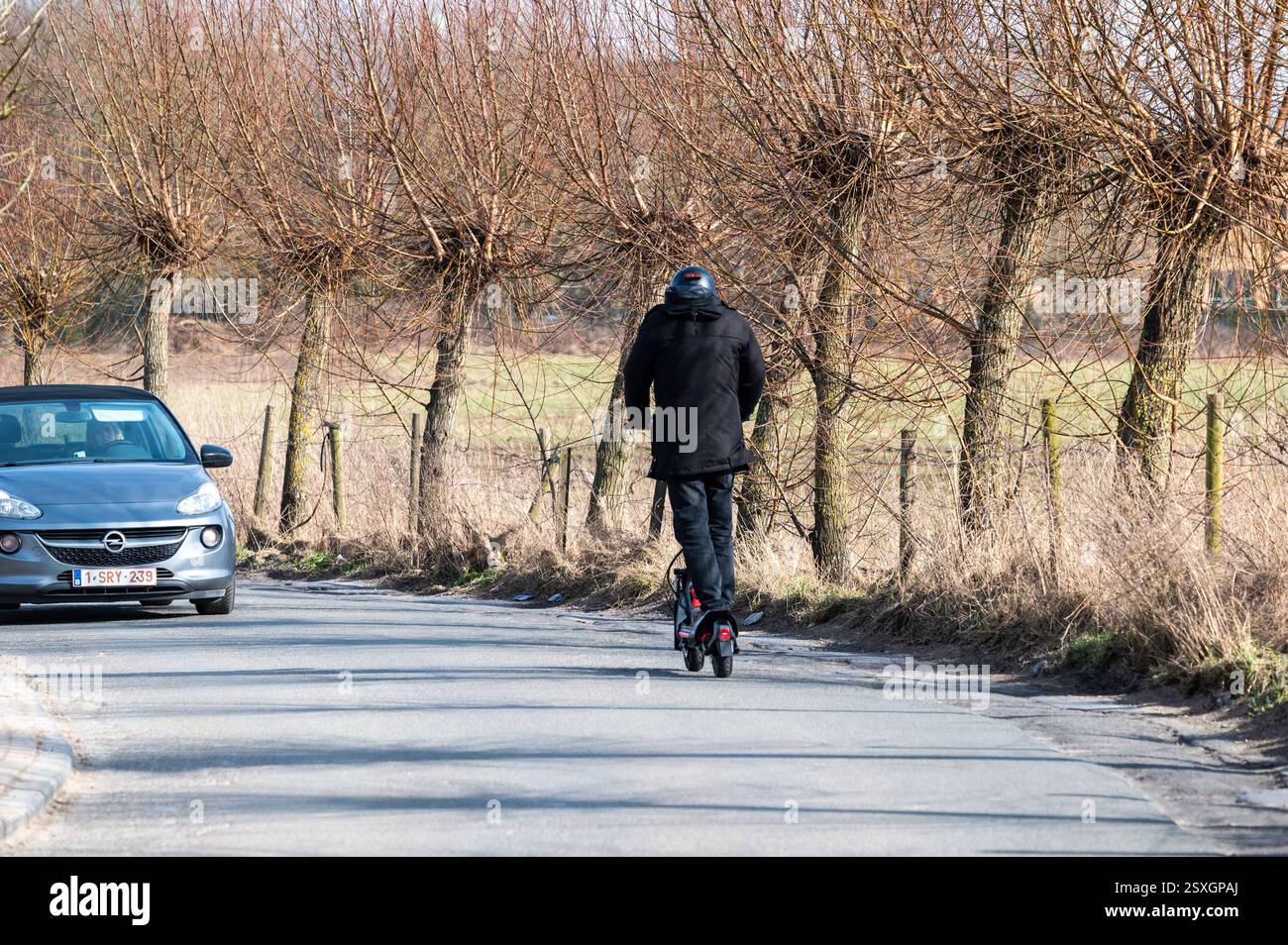 Step driver and car passing in a corner in Dilbeek, Flemish Brabant ...