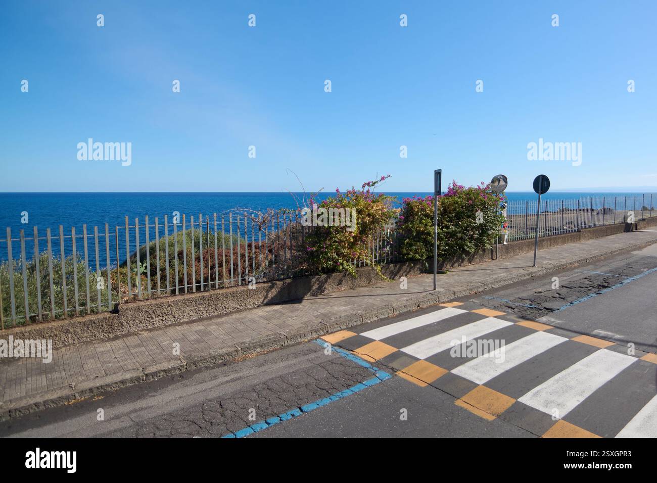 Coastal pedestrian safety. A pedestrian crossing sign stands by a ...