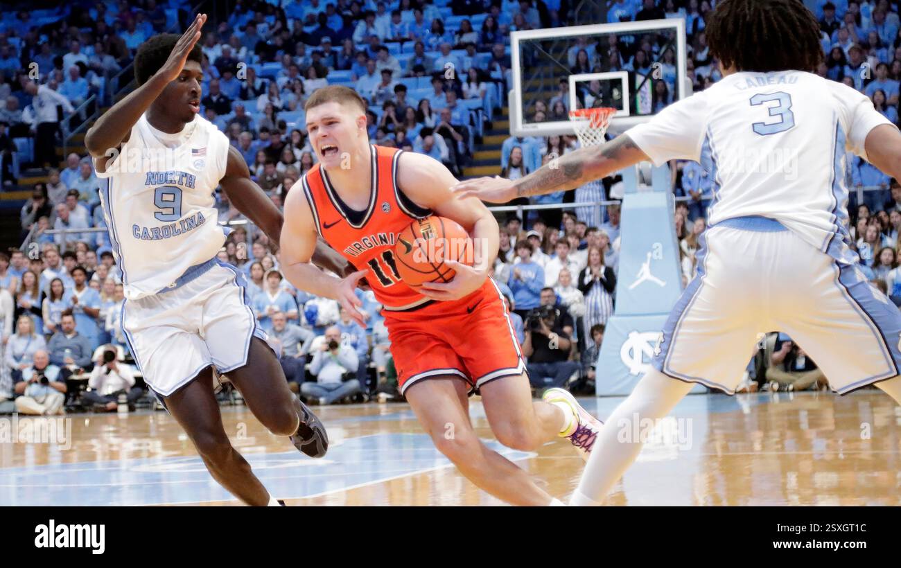 Virginia guard Isaac McKneely (11) drives between North Carolina guard ...