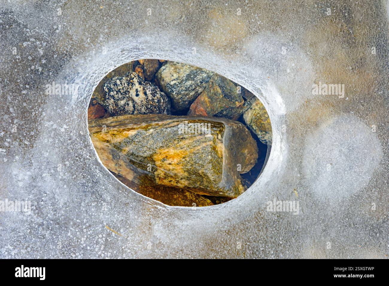A circular hole reveals textured rocks underneath a smooth stone ...