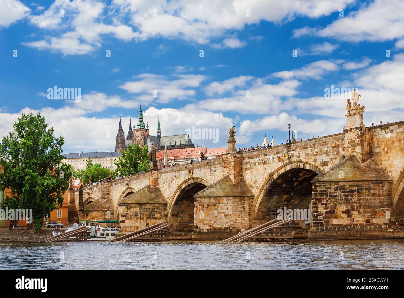 Tourism in Prague. Czech people and tourists cross the famous Charles ...