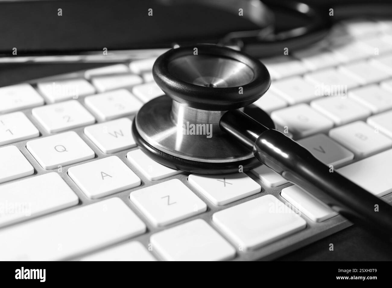 Technical support concept. Stethoscope and keyboard on black background ...