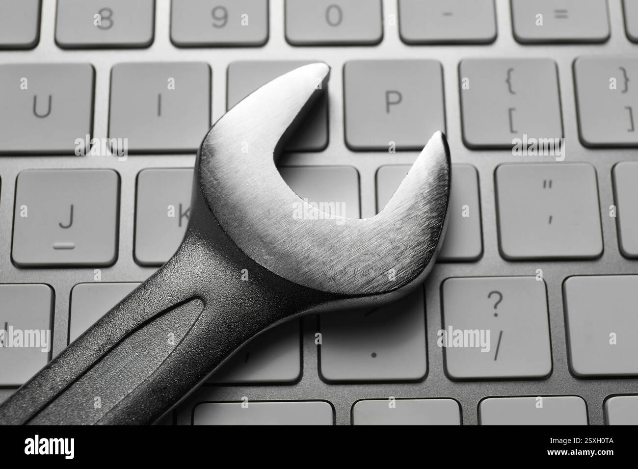 Technical support concept. Wrench on keyboard, top view Stock Photo - Alamy