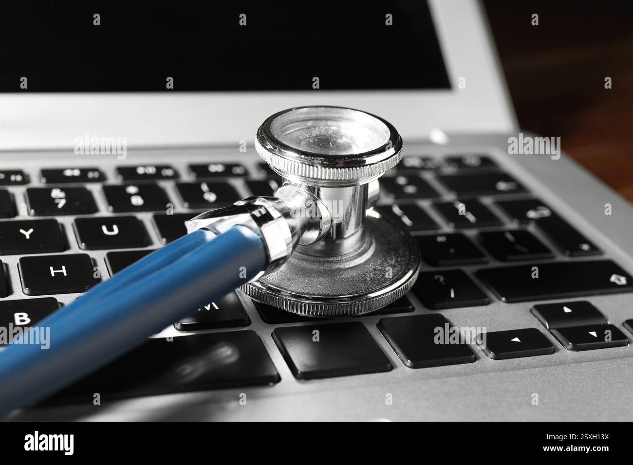 Technical support concept. Stethoscope on laptop keyboard, closeup ...