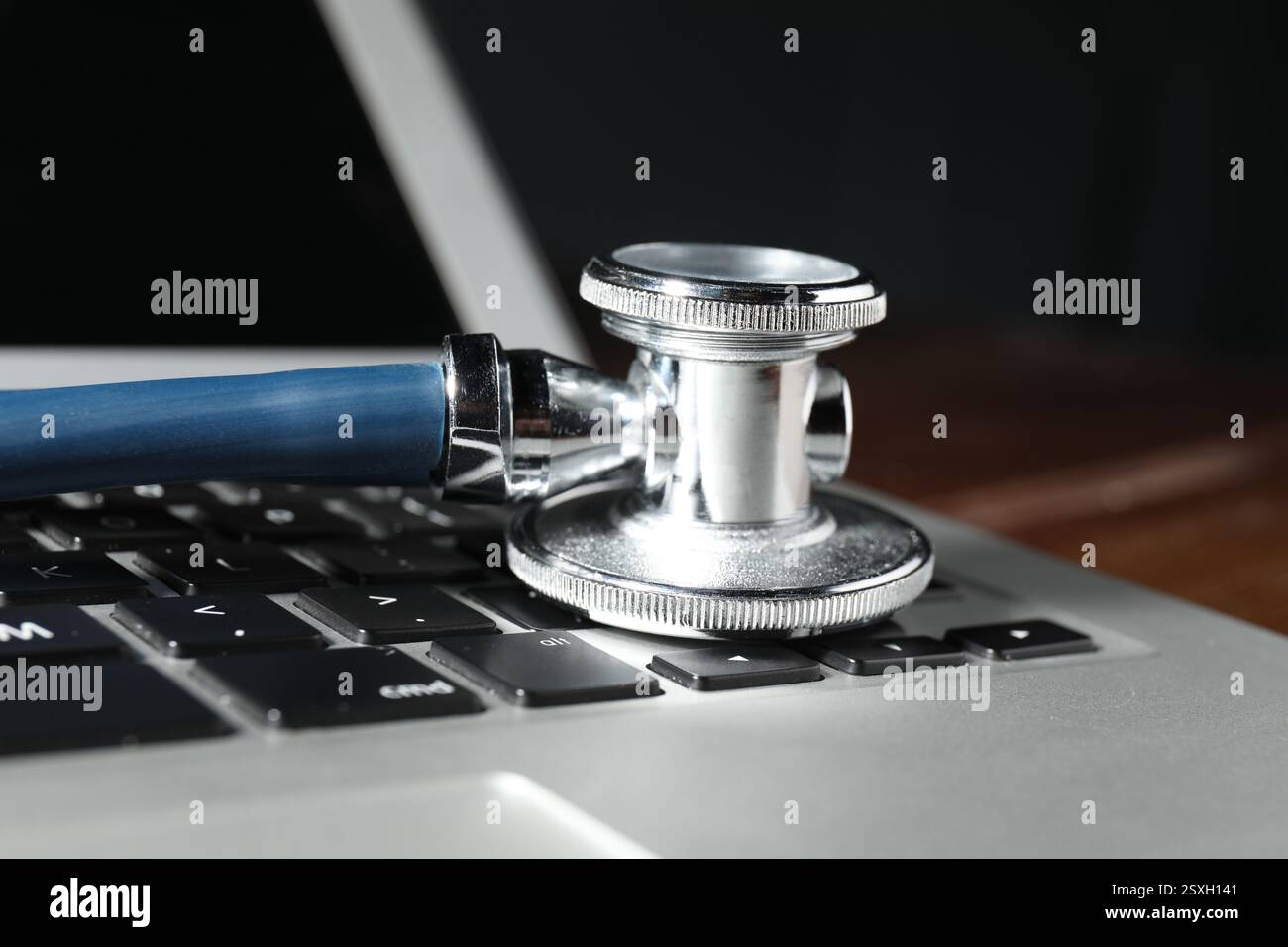 Technical support concept. Stethoscope on laptop keyboard, closeup ...