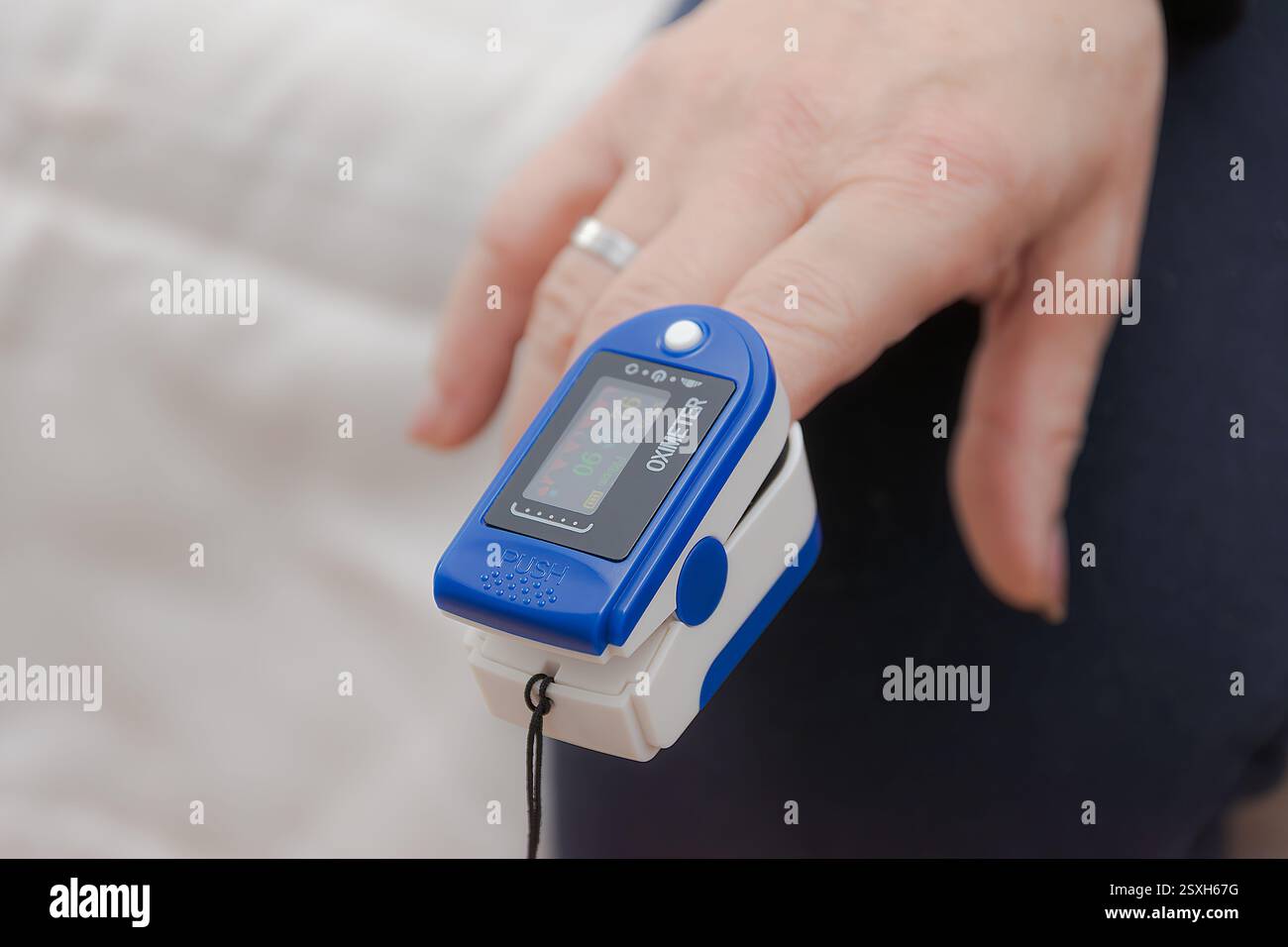Pulse oximeter placed on patient`s finger measuring oxygen saturation ...