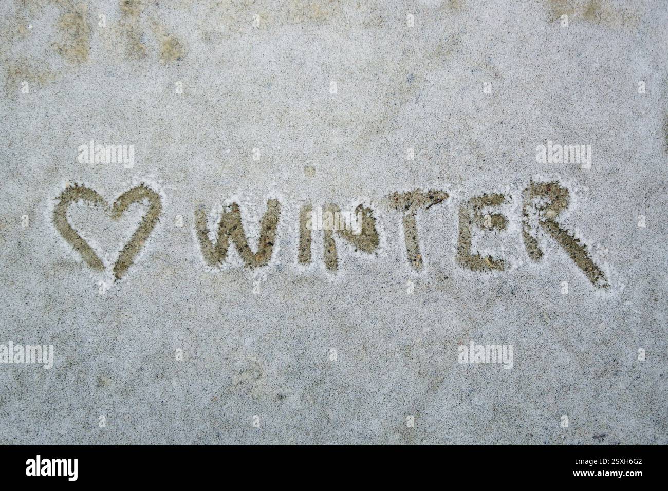 The word winter with heart next to it written in the snow Stock Photo ...