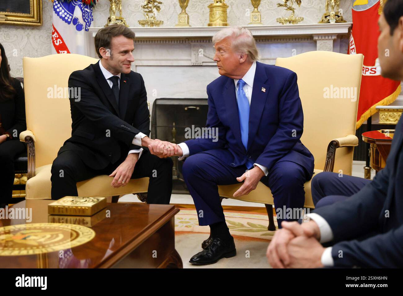President Donald Trump, right, shakes the hand of France's President ...