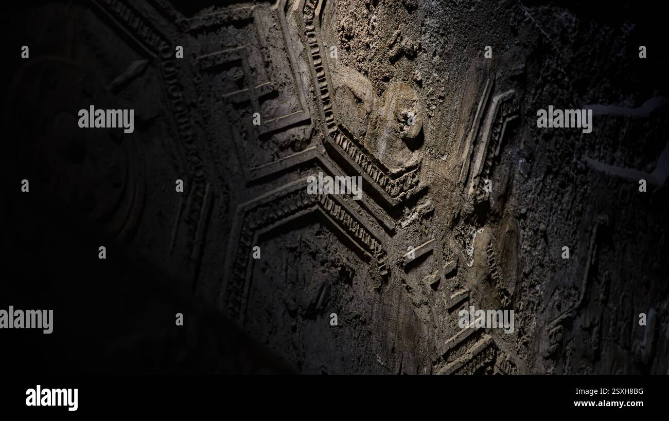 Inside a ancient roman ruin in Pompeii. Intricately carved wall relief ...