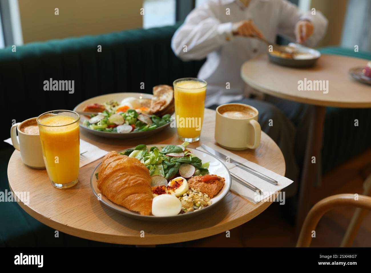 Woman having tasty breakfast in cafe, focus on different meals and ...