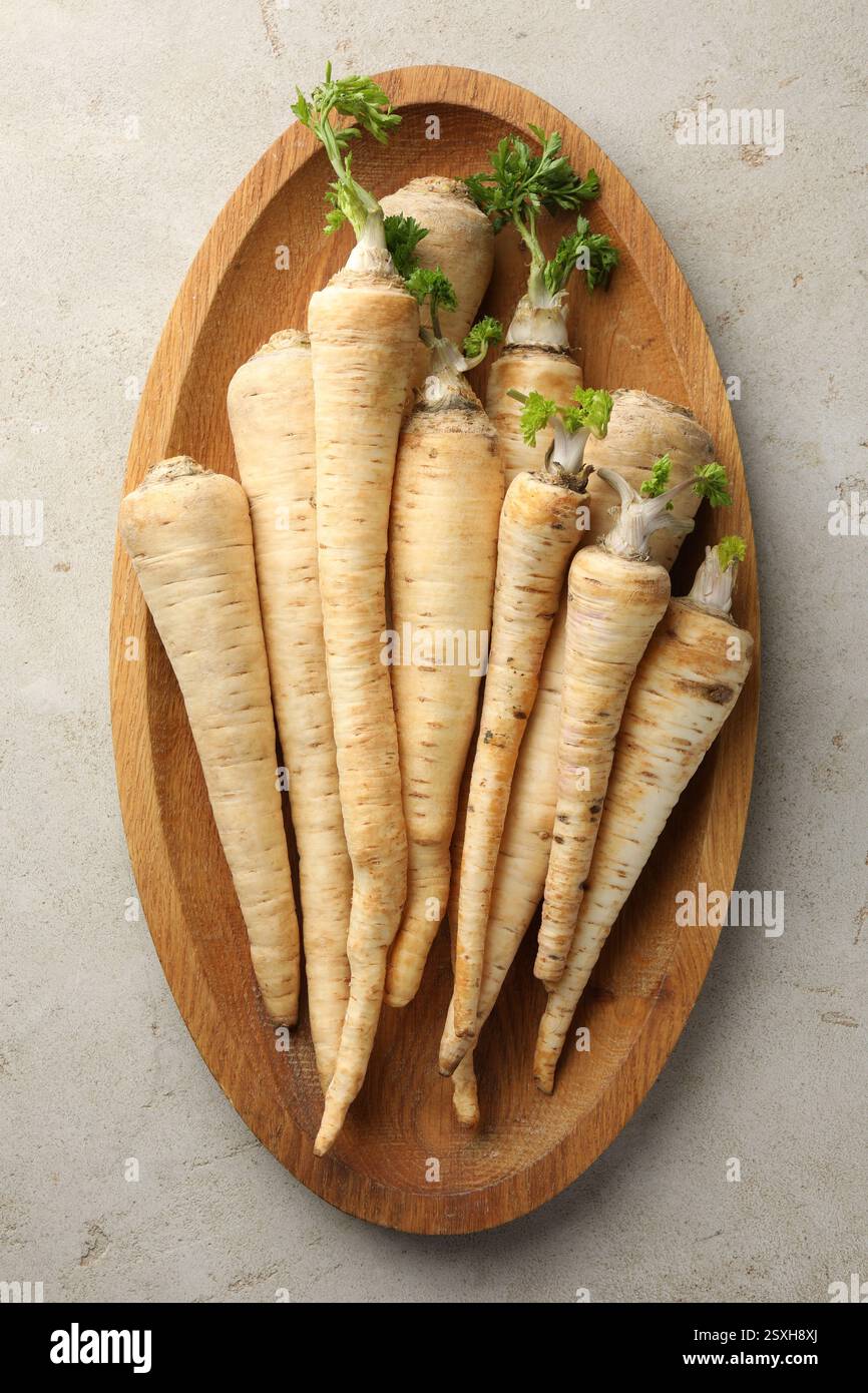 Many fresh parsley roots on grey table, top view Stock Photo - Alamy