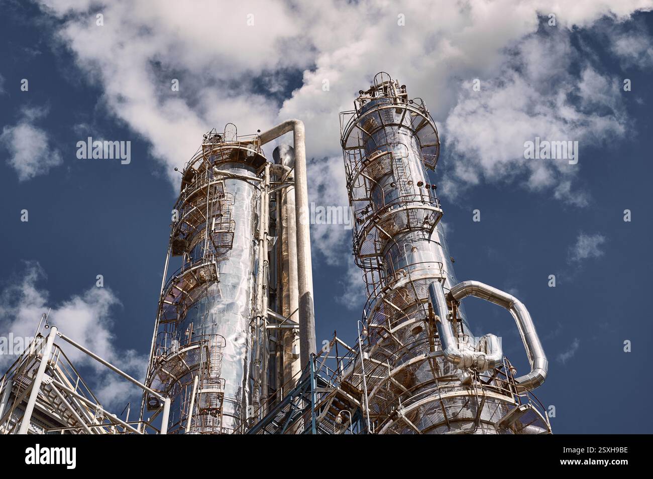 Modern chemical plant showcasing distillation columns against a bright ...