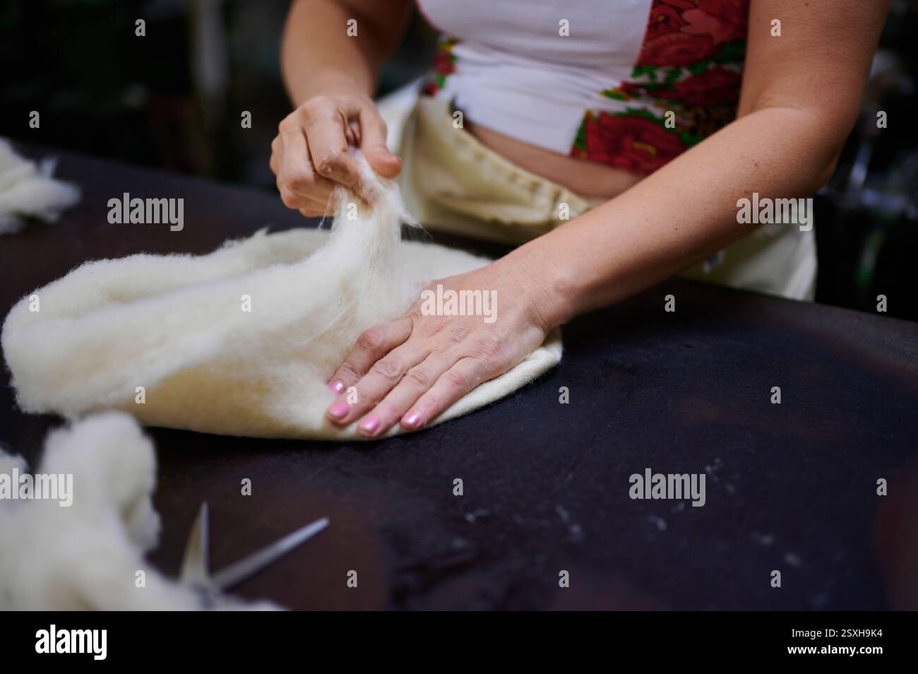 Skilled artisan creates exquisite felt pieces in a vibrant factory ...