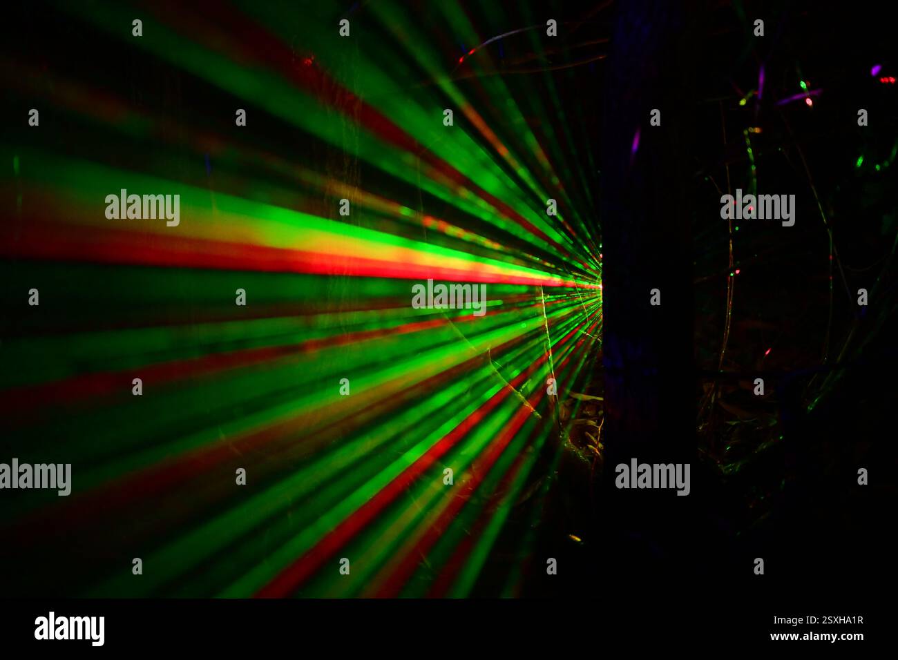 Abstract image of green and red laser beams in a dark environment ...