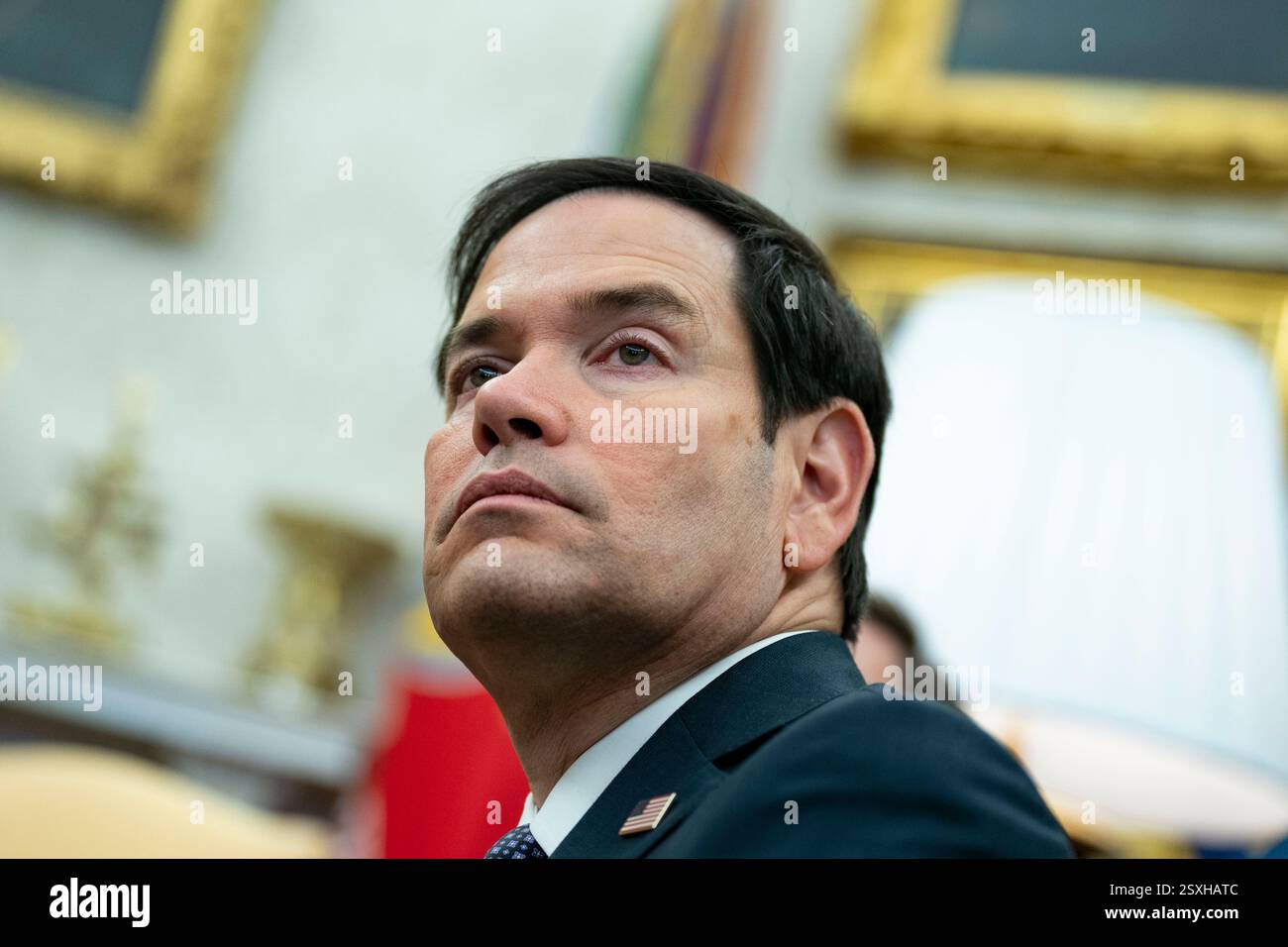 Secretary of State Marco Rubio looks on while President Donald Trump ...