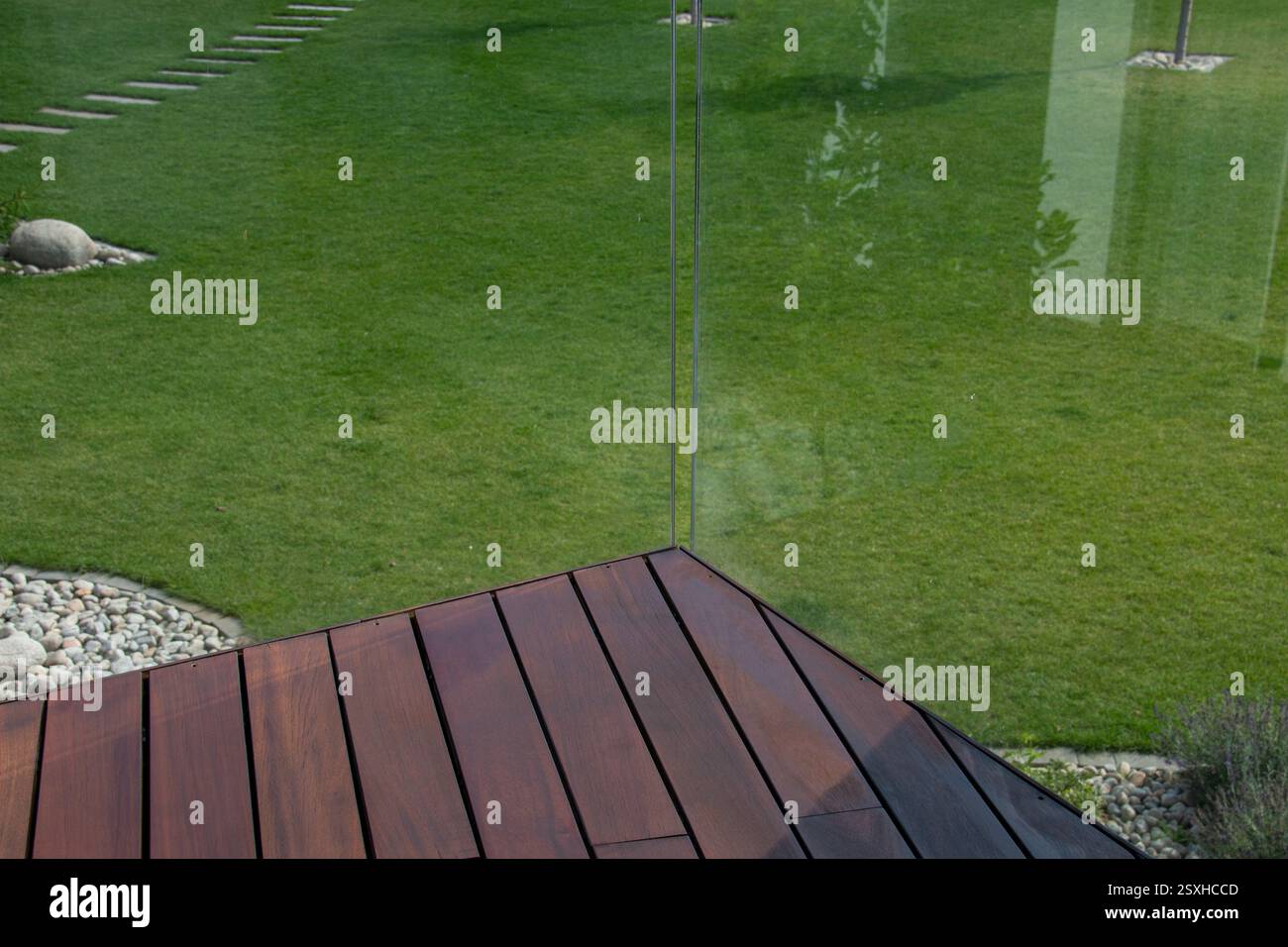 Clear glass railing edge with wooden deck on balcony, architectonic ...