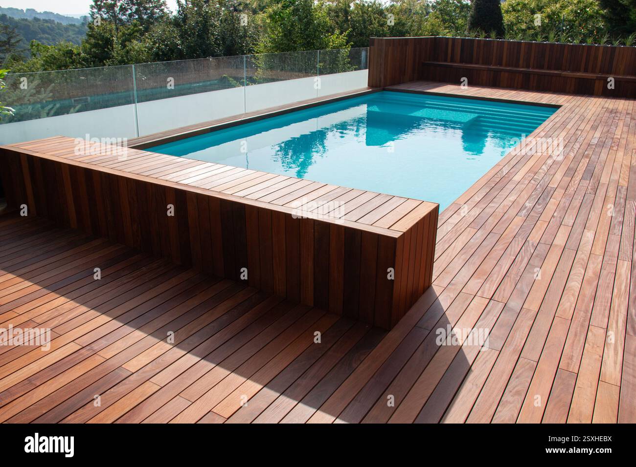 High-end swimming pool with wooden deck flooring design overlooking ...
