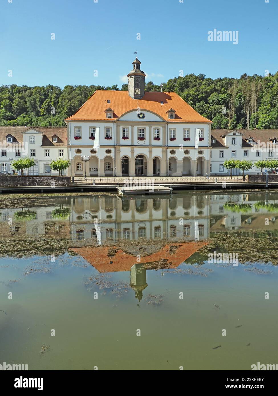 The historic town hall of Bad Karlshafen is reflected in the water of ...