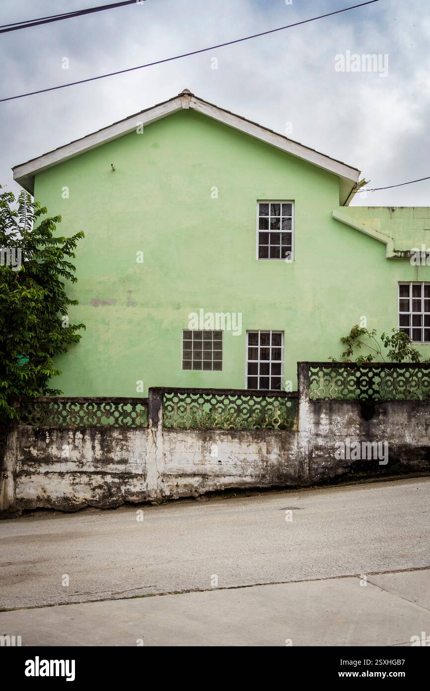 Green house with dirty white wall inSan Ignacio, Cayo District, Belize ...