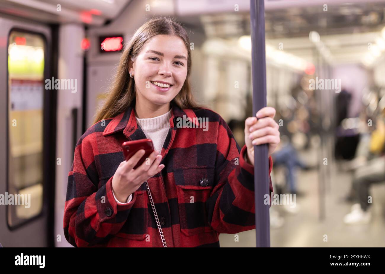 Woman typing on smartphone subway hi-res stock photography and images ...