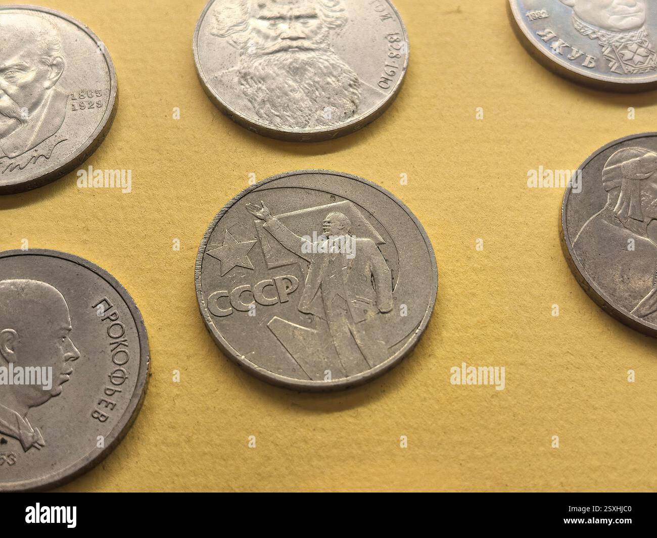 Bobruisk, Belarus - February 16, 2025: Soviet-era coins lay on a yellow ...