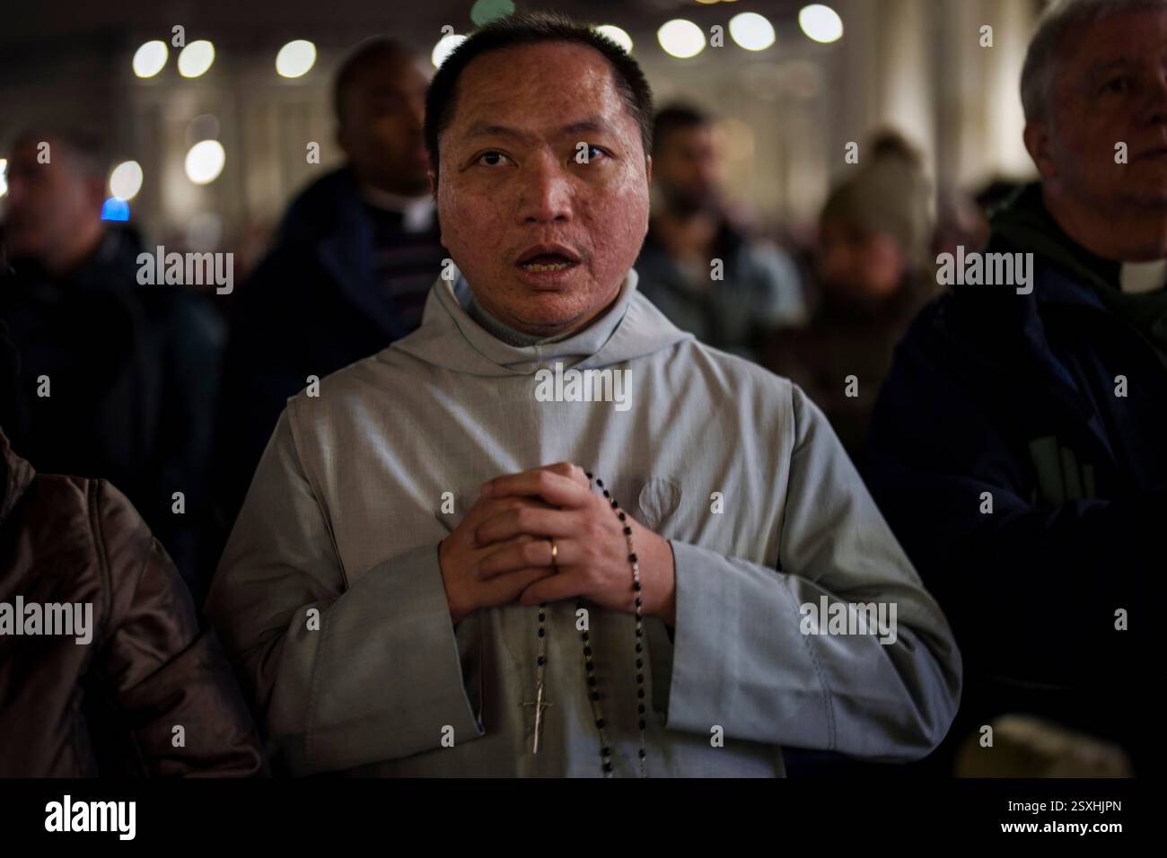 A Catholic priest attends a prayer of the Rosary for Pope Francis in St ...