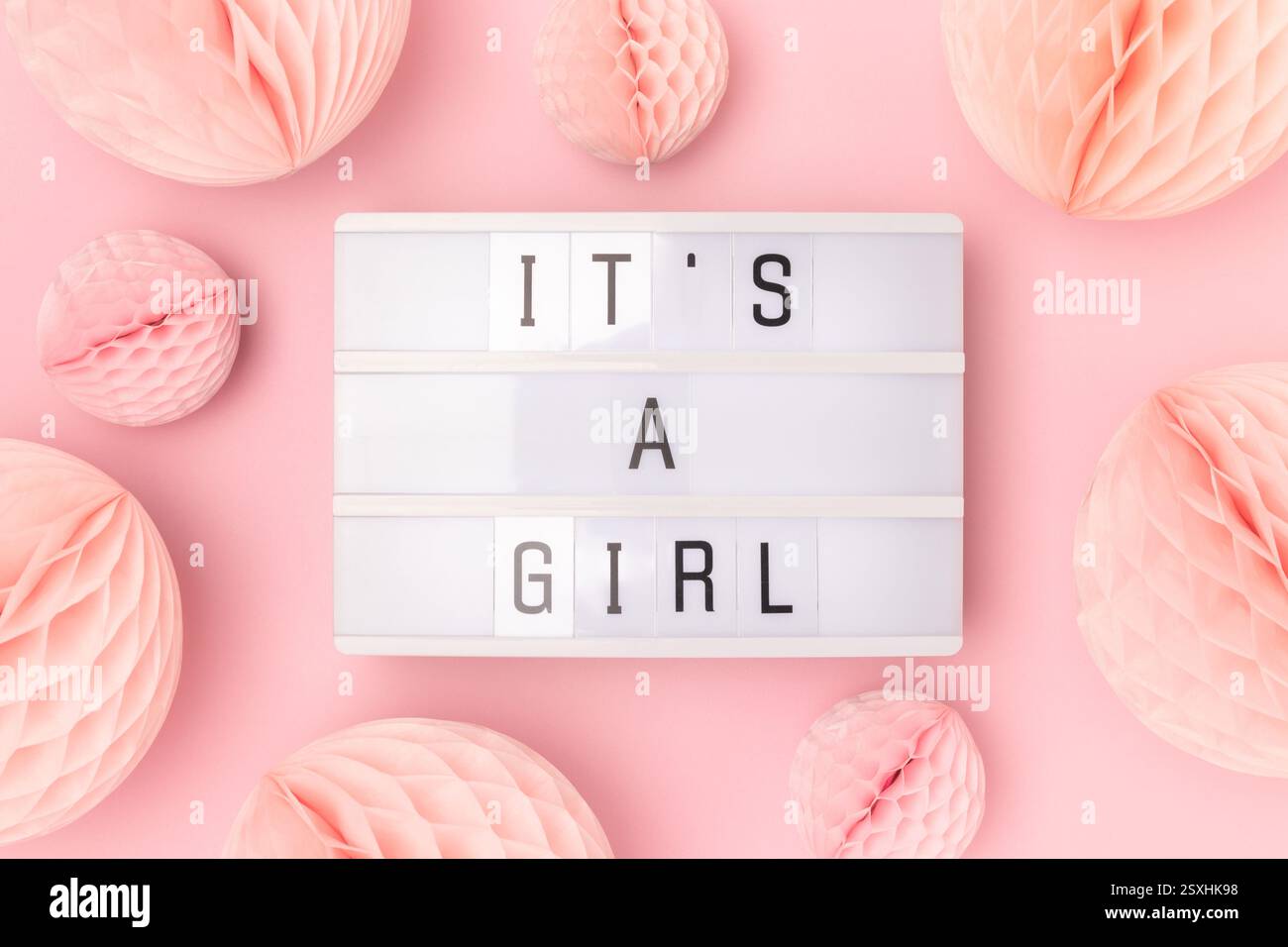 It's a girl. Lightbox with letters and tissue paper balls in a pink ...