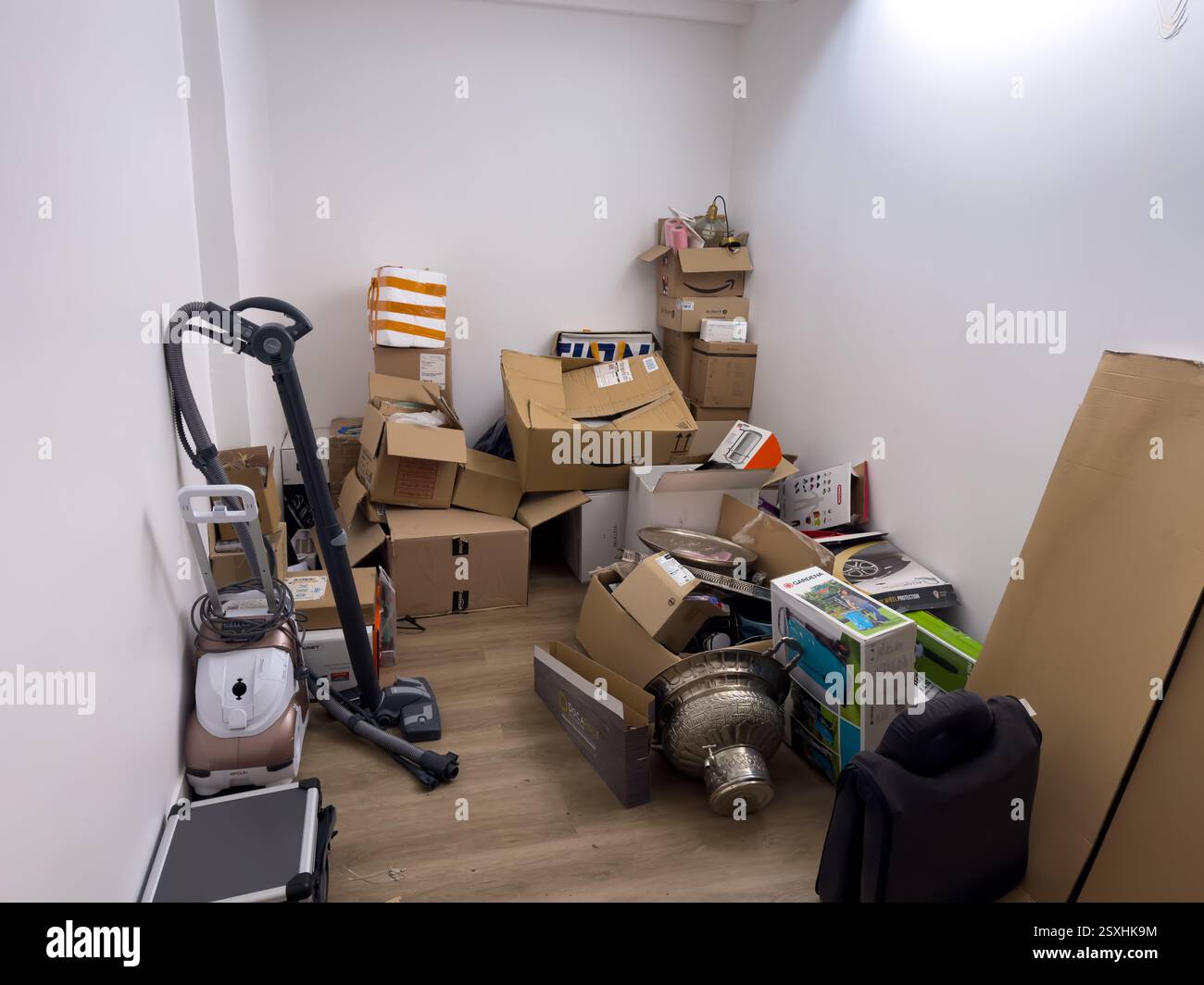 Cluttered room filled with cardboard boxes and scattered items Stock ...