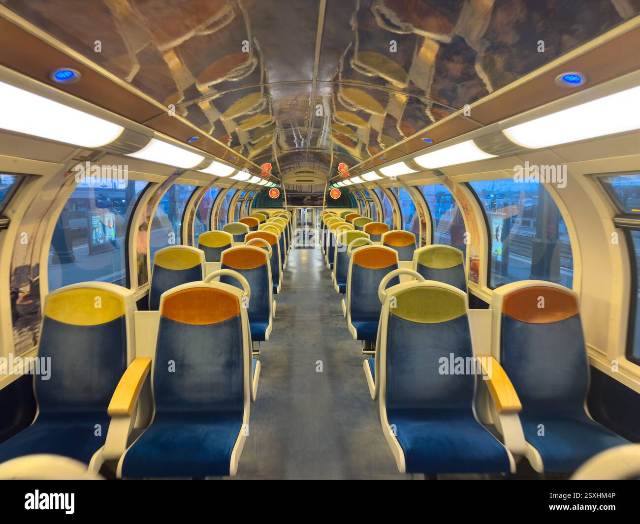 Modern train interior showcases vibrant colors and comfortable seating ...