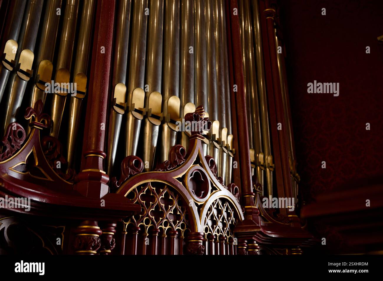 A grand pipe organ with intricate wooden carvings and gleaming metal ...