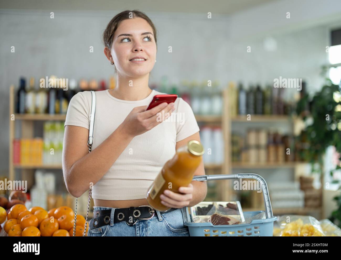 Young woman scanning qr code of peach juice Stock Photo - Alamy