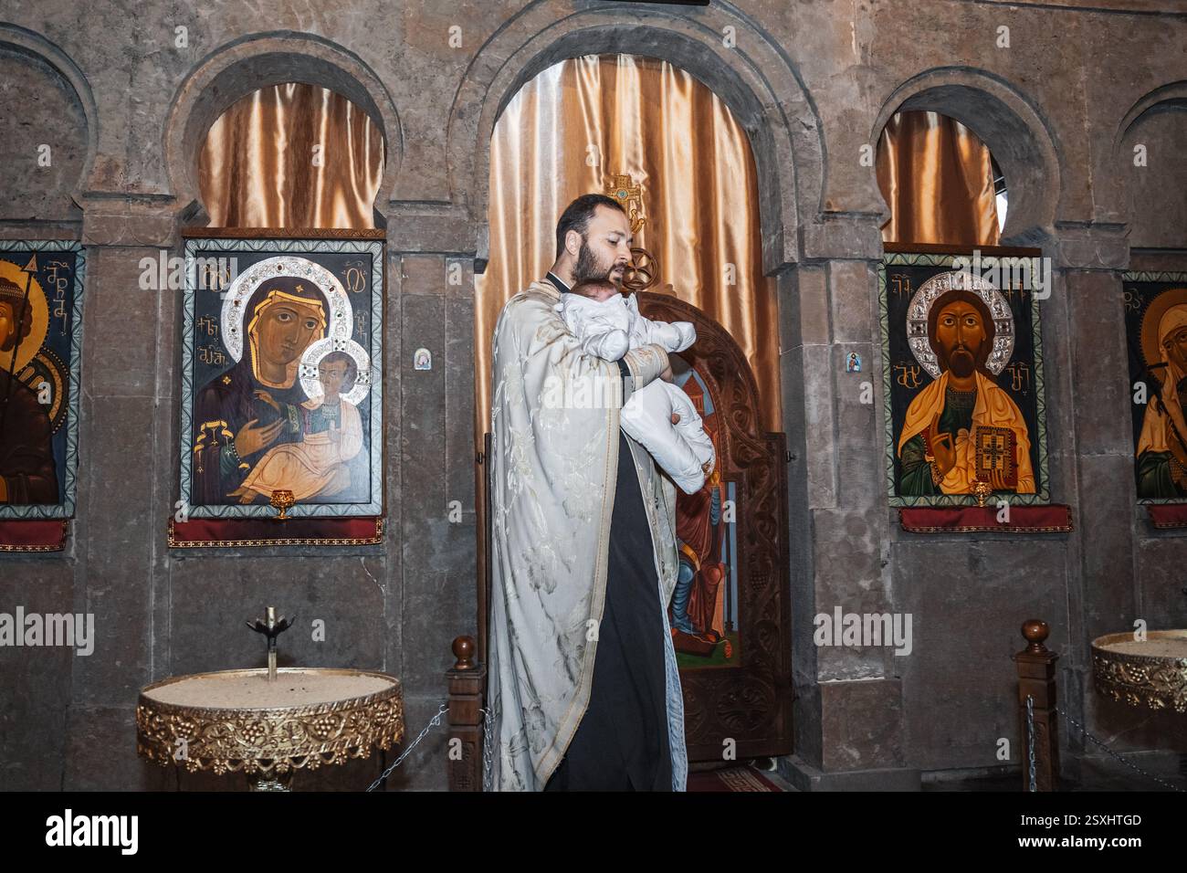 An Orthodox priest reads prayers during a religious ceremony in an ancient church. An ...