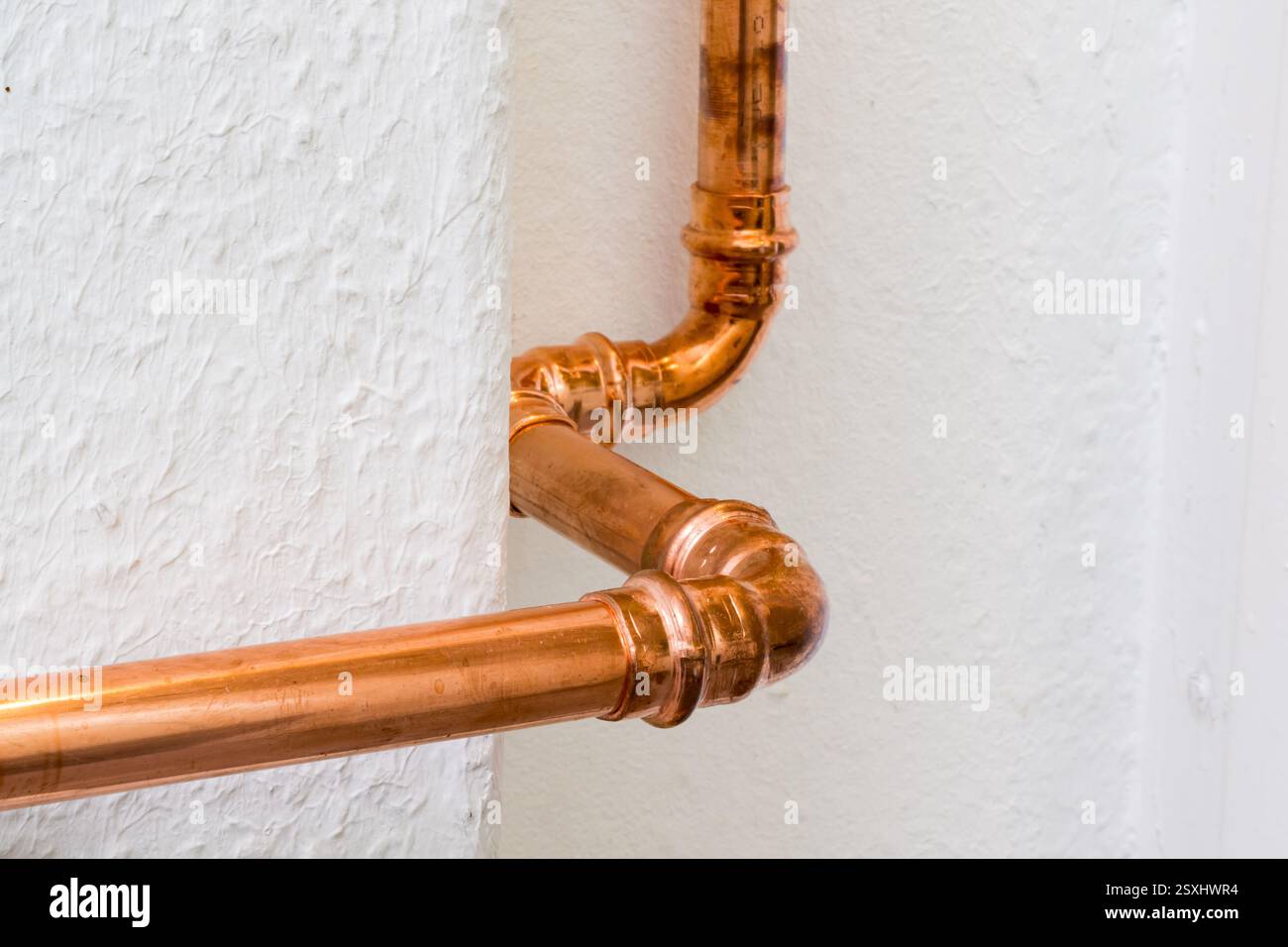 A hot water pipe construction around a corner in a small space at a ...