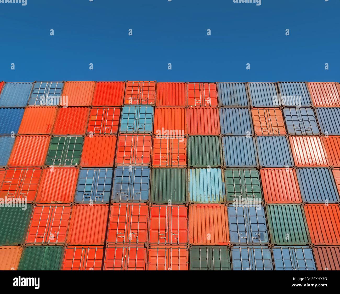 Looking up at a wall of shipping containers Stock Photo - Alamy
