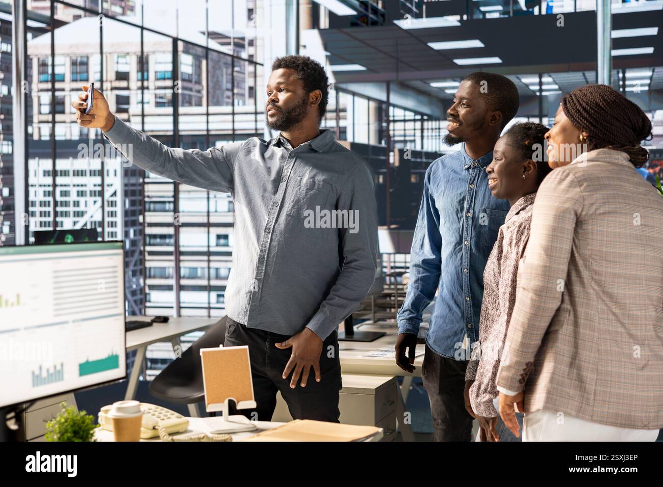 African american team members take pictures at the office on a work ...