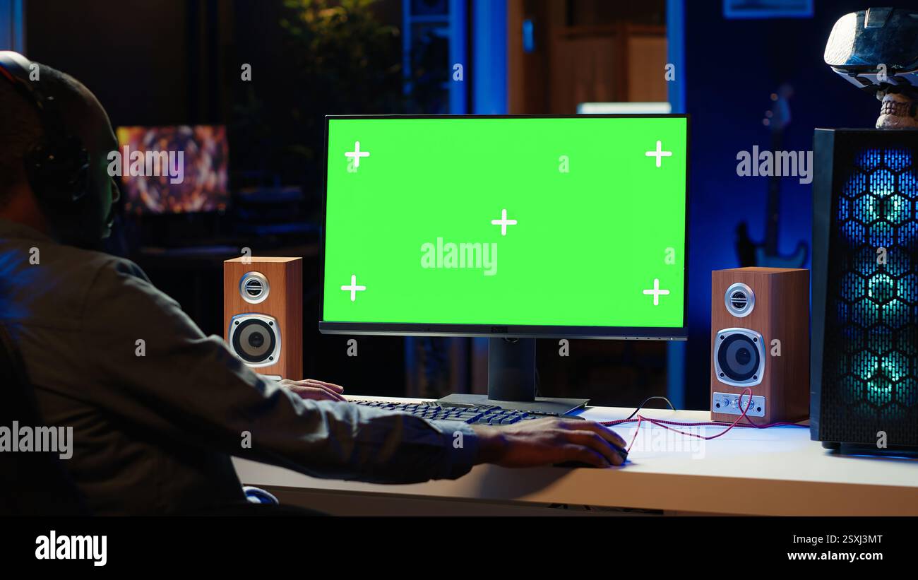 Professional streamer looking at isolated screen monitor, competing in ...