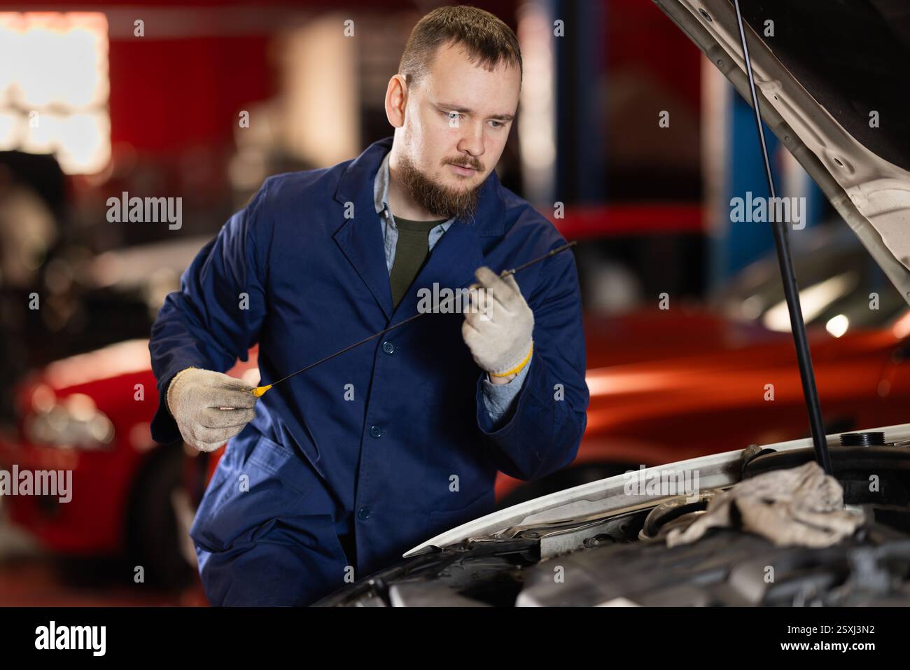 Mechanic checks suspension in hi-res stock photography and images - Alamy