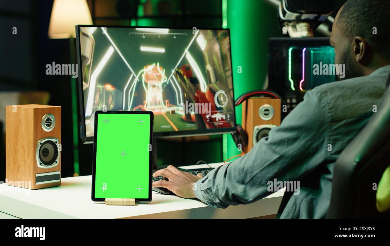 Chroma key tablet next to man playing high FPS singleplayer videogame ...