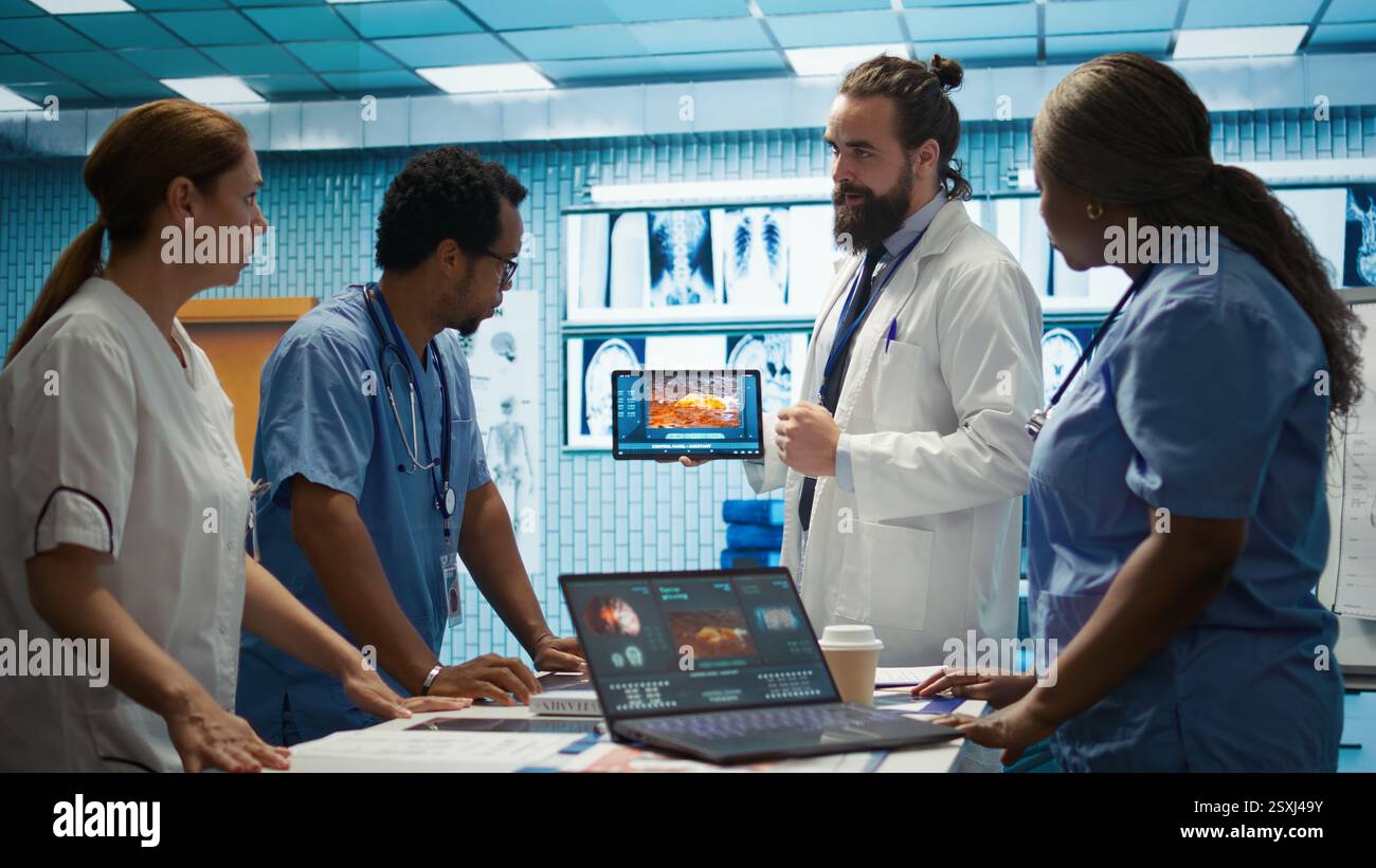 Neurology specialist examines magnetic resonance imaging brain scan with team during a meeting ...