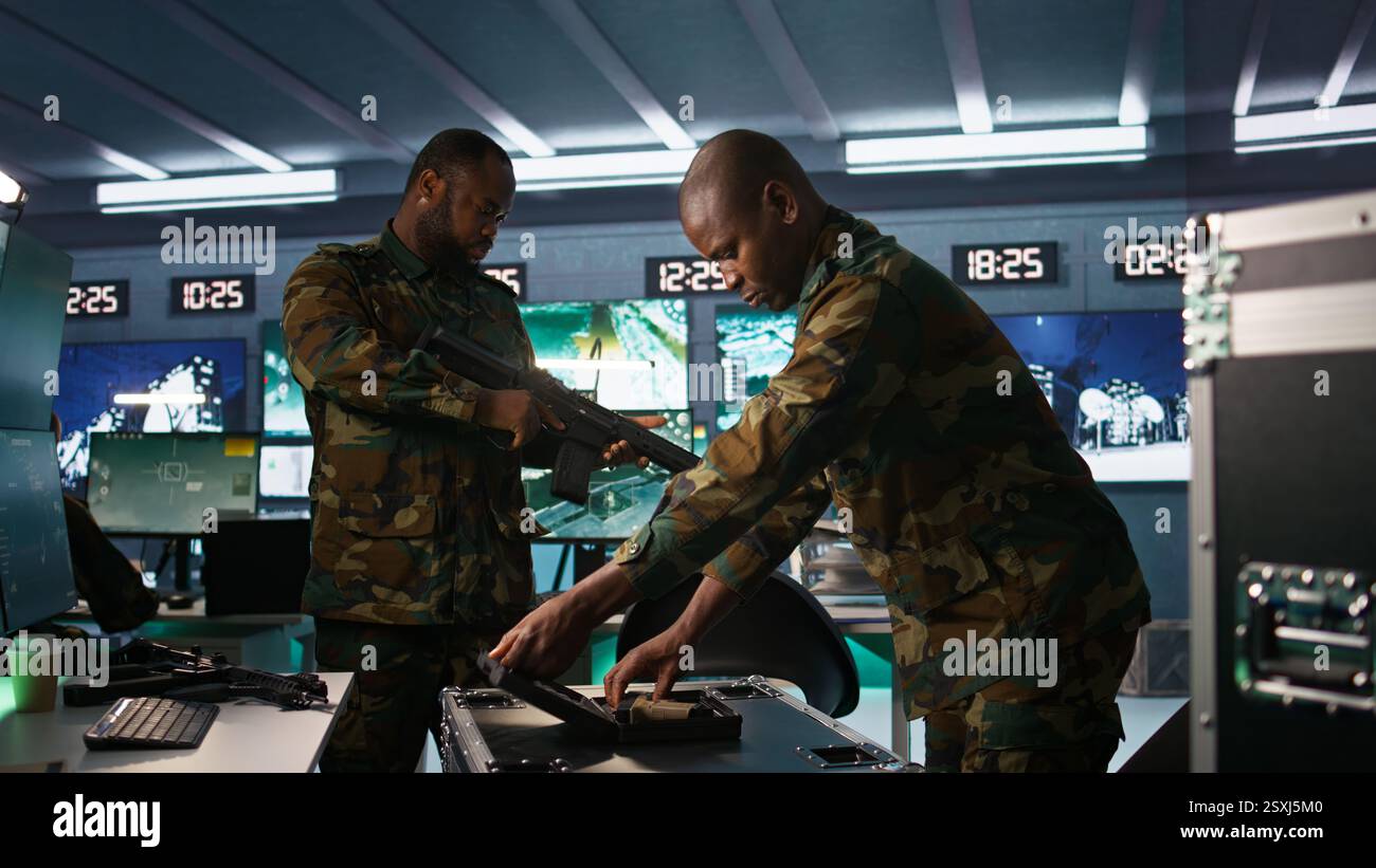 Military officers working together to check guns in command post ...