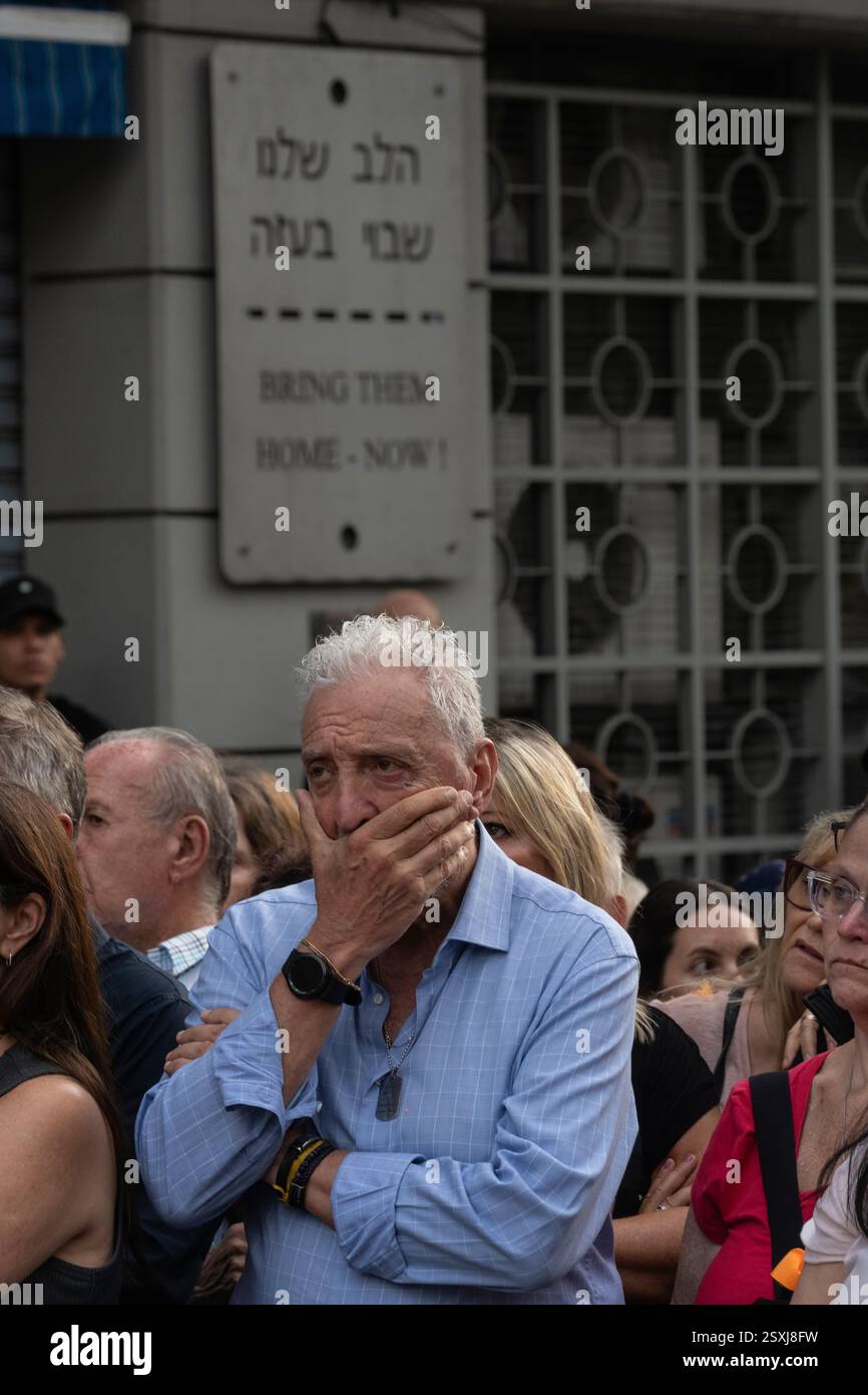 A man gestures at an event in support of relatives of the hostages and ...