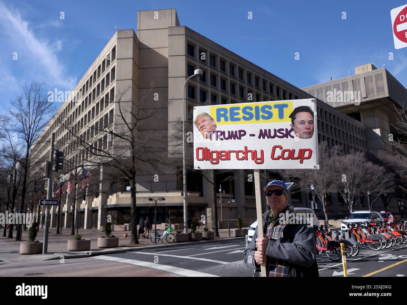 Washington Dc, Virginia, USA. 24th Feb, 2025. A man holding a placard ...