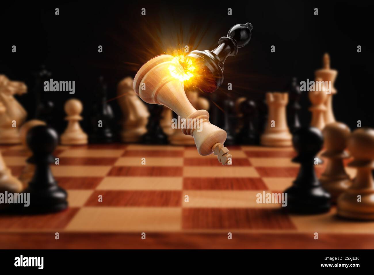 Chess game. Black bishop beating white king in air over chessboard ...