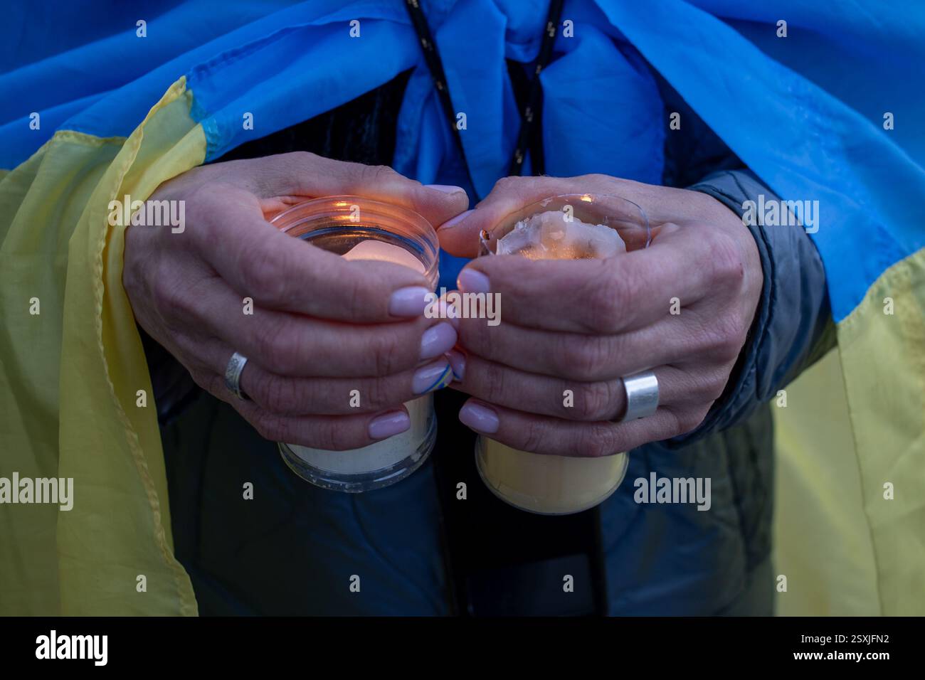 A woman carries candles during a rally of Ukrainian residents in front ...