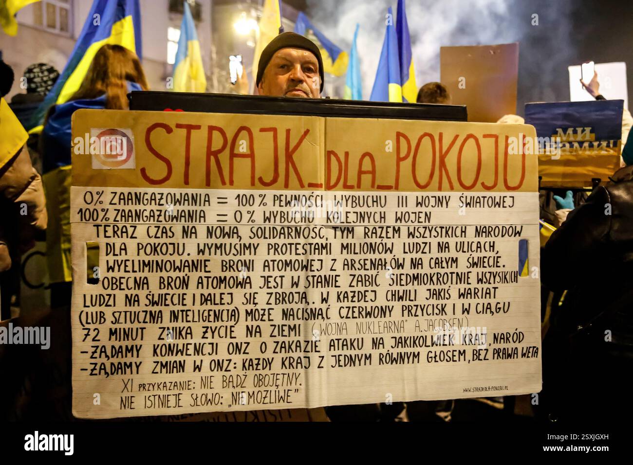 Warsaw, Poland. 24th Feb, 2025. A man shows a pacifist placard during ...