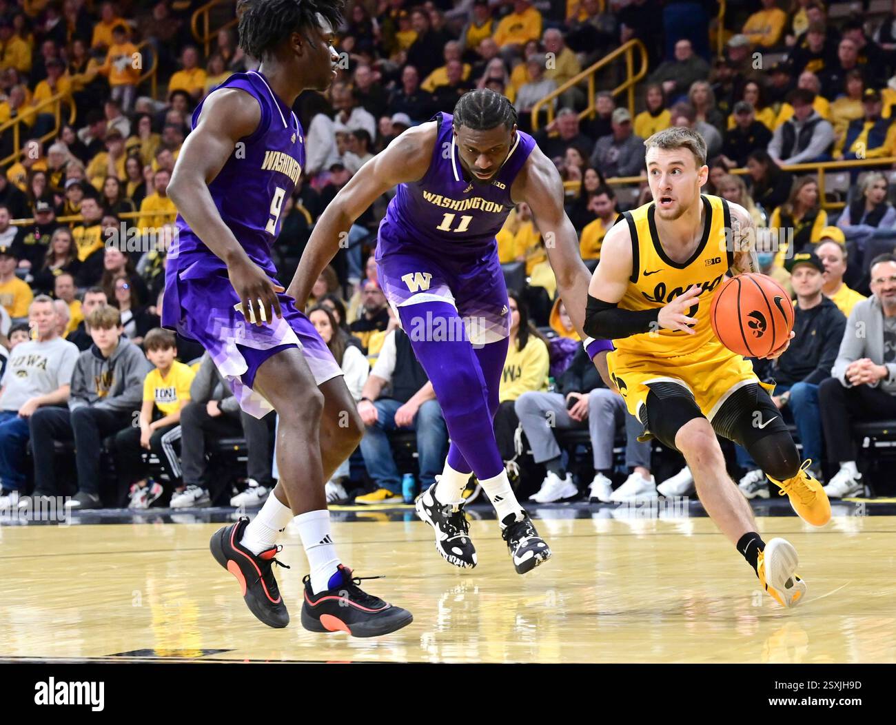 IOWA CITY, IA - FEBRUARY 22: Iowa guard Brock Harding (2) drives around ...