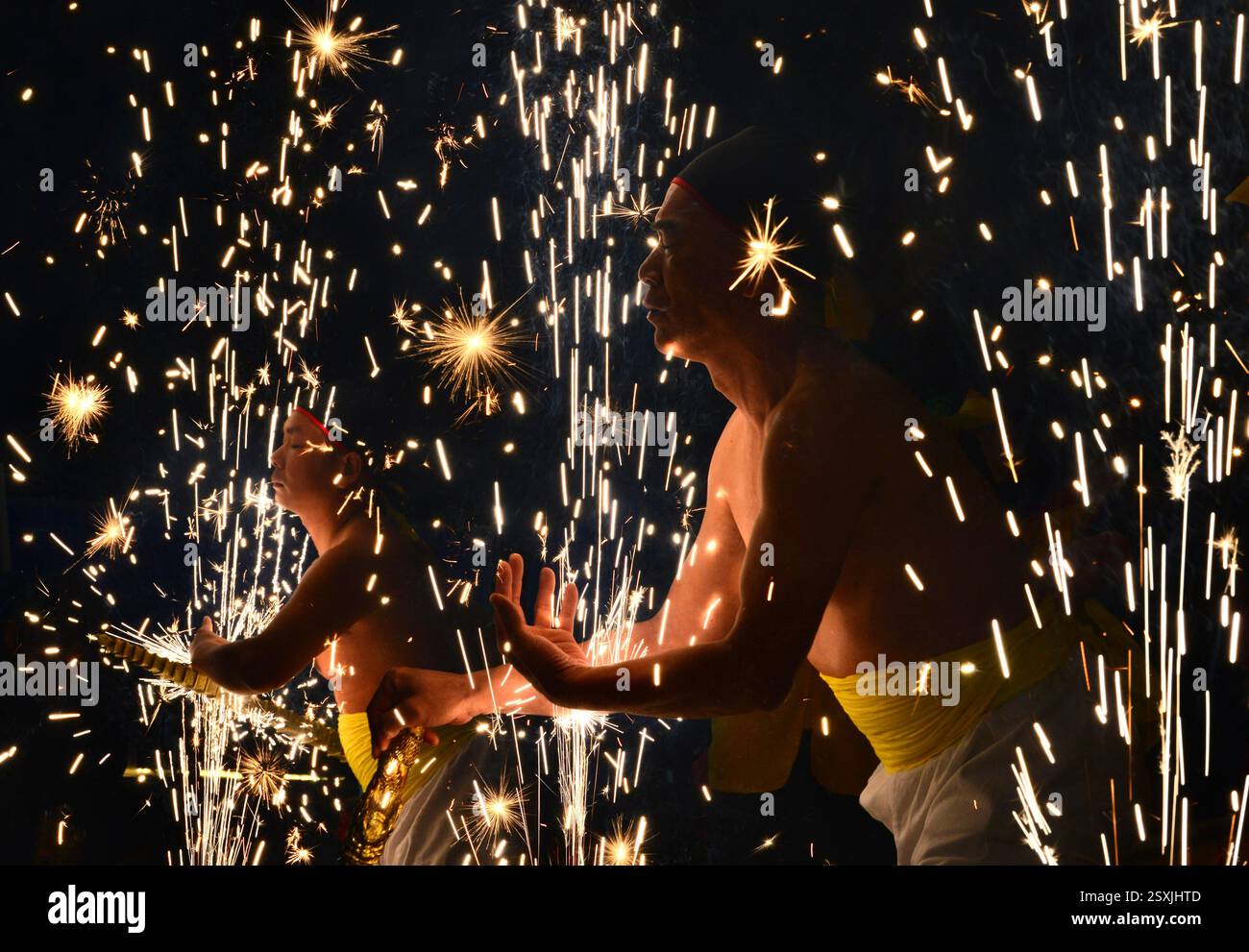 Putian,China.23th February 2025. Folk artists perform "firework eating ...