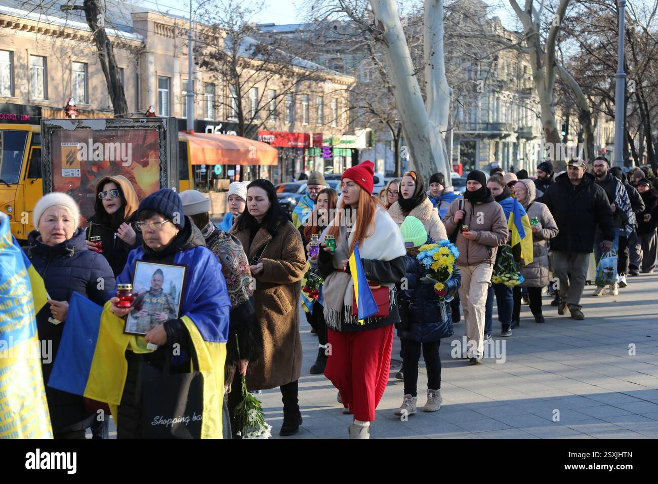 Participants of the commemorative procession walk along ...